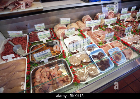 A butcher displays cuts of meat for sale to customers during the annual ...