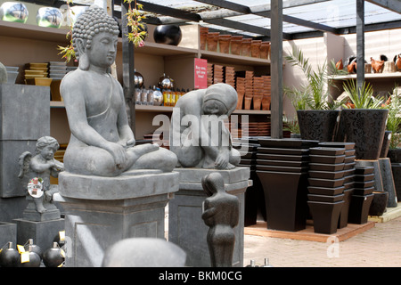 Statues and pots on racks at Brookfields Garden Centre Stock Photo - Alamy