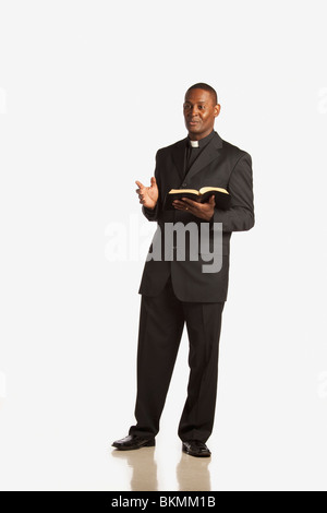 A Man Wearing A Clerical Collar And Preaching From The Bible Stock ...
