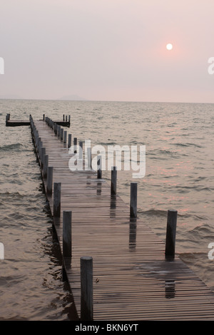 A rickety wooden pier stretches into the Golf of Thailand from the ...