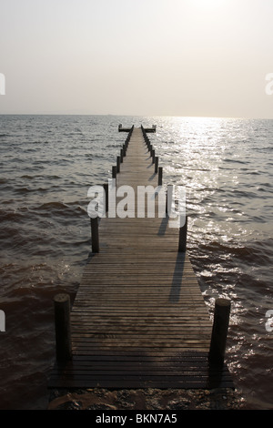 A rickety wooden pier stretches into the Golf of Thailand from the ...