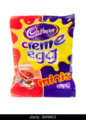 A packet of cadburys mini creme eggs with one egg out of packet against ...