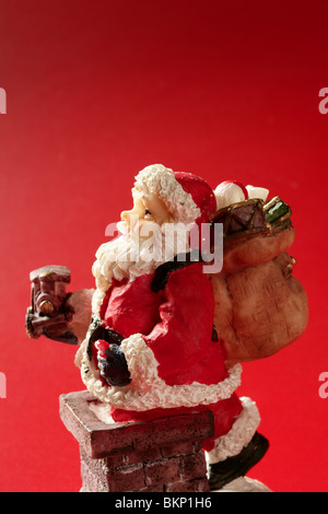 Santa Claus figurine over red background, studio shot Stock Photo - Alamy