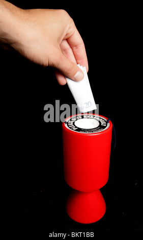 charity collection tin with twenty euros Stock Photo - Alamy