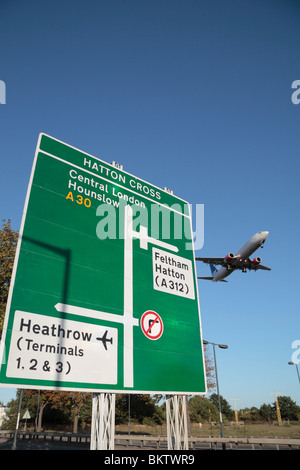 Hatton Cross station sign with jet airliner plane on finals to land at ...