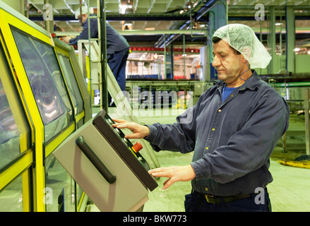 Two workers checking machine Stock Photo - Alamy