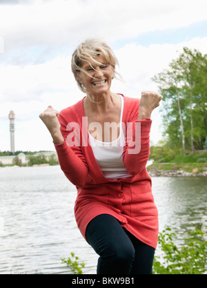 A person expressing freedom - reaching up into the sky against a sunset ...