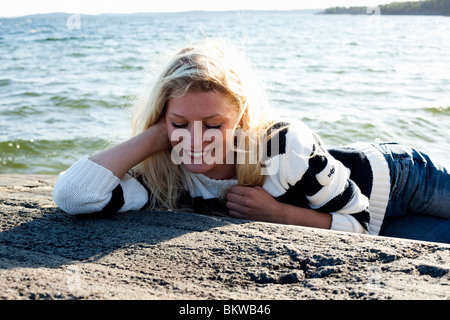 Girl leaning against a rock on the island of Cozumel, Mexico Stock ...