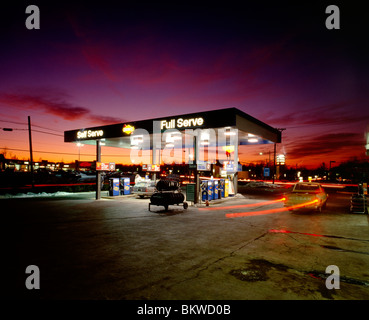 Night view of gas station convenience store with brightly lit windows ...
