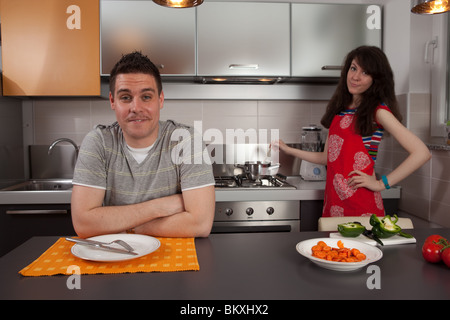 Girl cooking for a hungry guy Stock Photo - Alamy