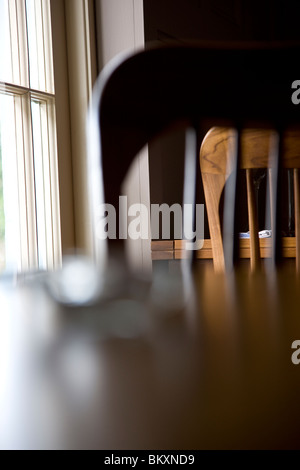 Wooden dining table and chairs in front of large sliding glass doors ...