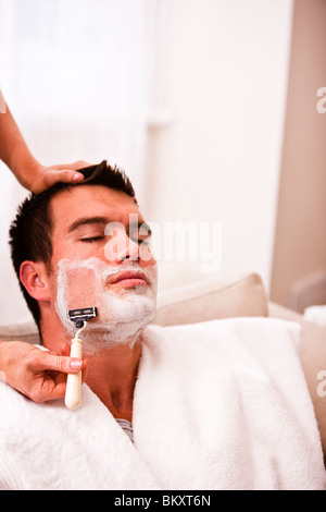Portrait Of Male Barber Giving Client Haircut In Shop Stock Photo - Alamy