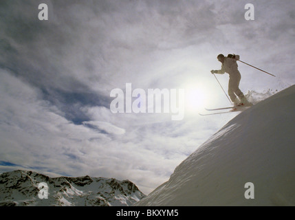 Man jumping off edge of slope while skiing Stock Photo - Alamy
