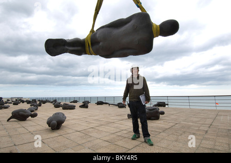 Antony Gormley human figure sculpture on rooftop, campus of University ...