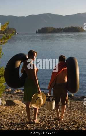 Men float on inner tubes from truck tires as they head out to fish on ...