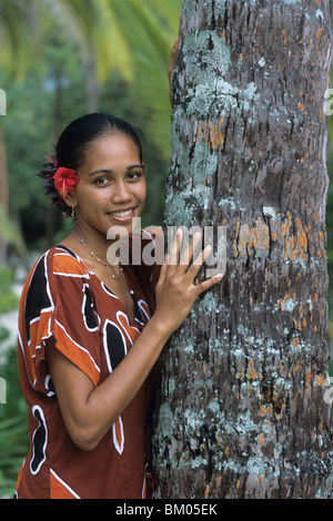 Pretty Polynesian woman smiling at the camera as she poses in front of ...