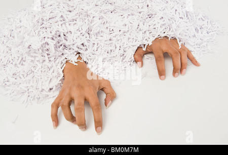 Human hands coming out of a heap of shredded paper Stock Photo - Alamy