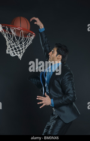 young asian adult dunking basketball on outdoor court Stock Photo - Alamy