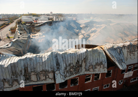 Large factory and warehouse collapsed and smoldering following major ...