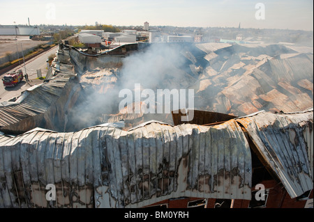 Large factory and warehouse collapsed and smoldering following major ...