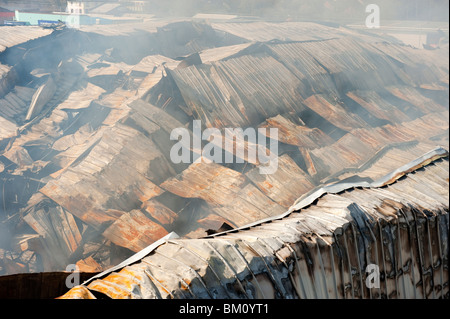 Large factory and warehouse collapsed and smoldering following major ...