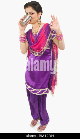 Woman drinking lassi and gesturing Stock Photo - Alamy