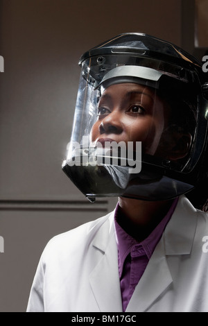 A medical worker wearing protective gear looks at the testing booth at ...