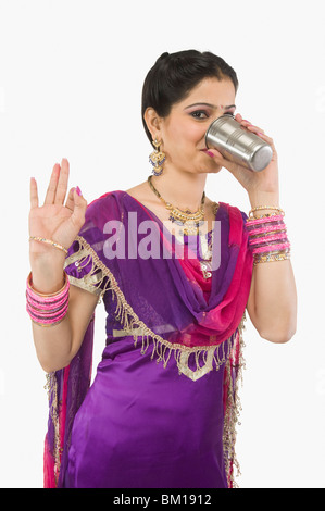 Woman drinking lassi and gesturing Stock Photo - Alamy