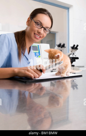Veterinarian writing clipboard with microscope medical equipments ...