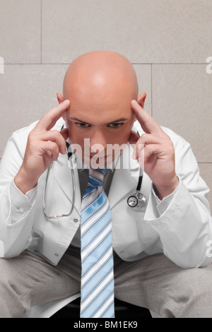 Young bald man stressed sitting on sofa at home Stock Photo - Alamy