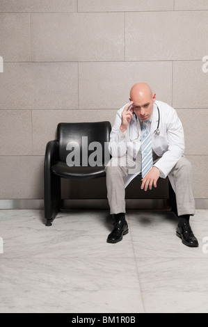 Young bald man stressed sitting on sofa at home Stock Photo - Alamy