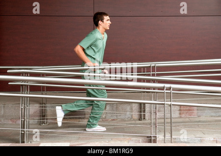 Male nurse running in a hospital Stock Photo - Alamy