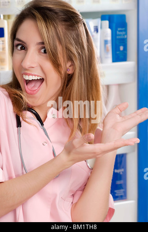 Young woman pharmacist with welcome expression at pharmacy Stock Photo ...