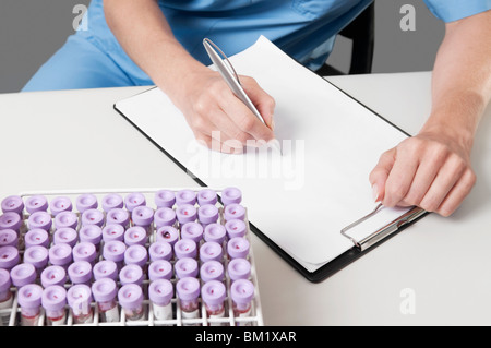 Close up of female technician preparing test sample while working in ...