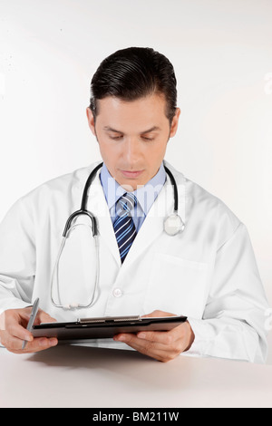 Vertical shot of a male doctor reading up before a surgery Stock Photo ...