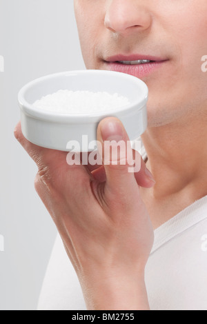 Handsome hispanic man holding therapy massage gun at physiotherapy ...