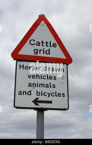 Road sign warning of Cattle grid, Horse drawn vehicles and animals ...