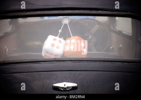 fluffy furry dice in car window Stock Photo - Alamy