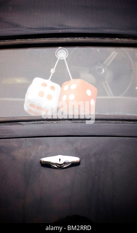 fluffy furry dice in car window Stock Photo - Alamy