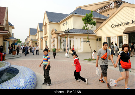 Chinese consumers walk at Beijing Scitech Premium Outlet Mall in ...