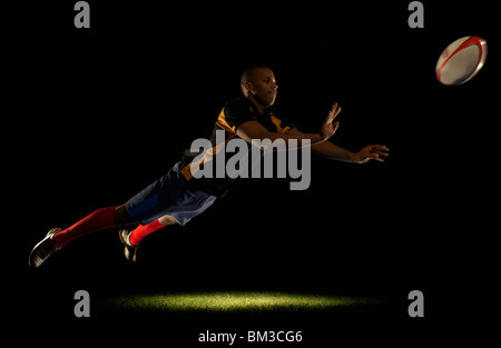 Rugby player passing ball Stock Photo - Alamy