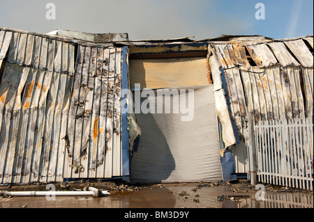 Large factory and warehouse collapsed and smoldering following major ...