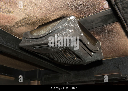 Melted air conditioning unit in office ceiling following fire Stock ...