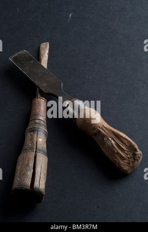 old worn screwdriver and chisel on black Stock Photo - Alamy