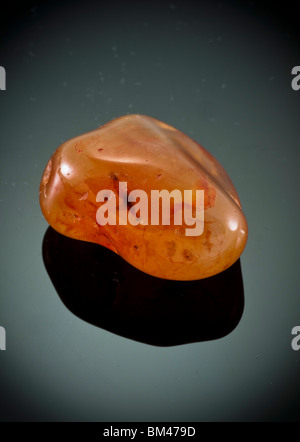 polished carnelian gem stone on dark background Stock Photo - Alamy