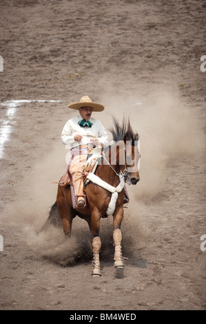A Mexican charro rides his horse at a charreria competition in Mexico ...