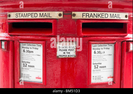 Close up of red franked mail letter box letterbox postbox England UK ...