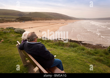 People visitors holidaymakers relaxing sitting on benches on the ...