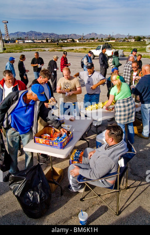 Homeless men line up for free food supplied by a local church in a ...