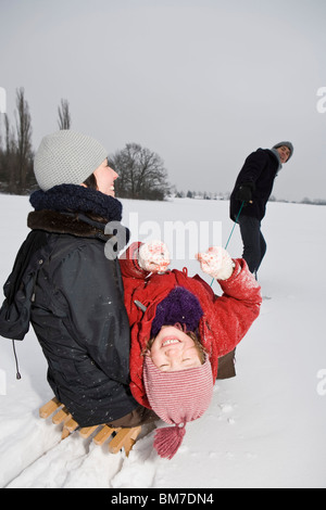 Mother Kids Snow Fun Sled Stock Photo - Alamy